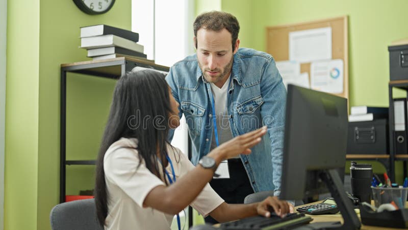 Two Workers Man and Woman Using Computer Speaking at the Office Stock ...