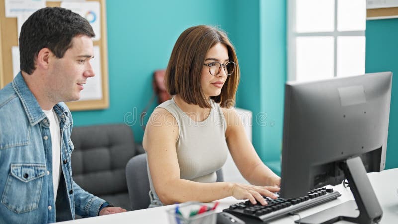 Two Workers Man and Woman Using Computer Working at the Office Stock ...