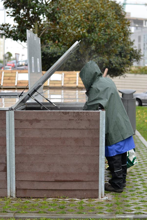 Two Workers are Managing a Community Composter Under the Rain. Concept ...