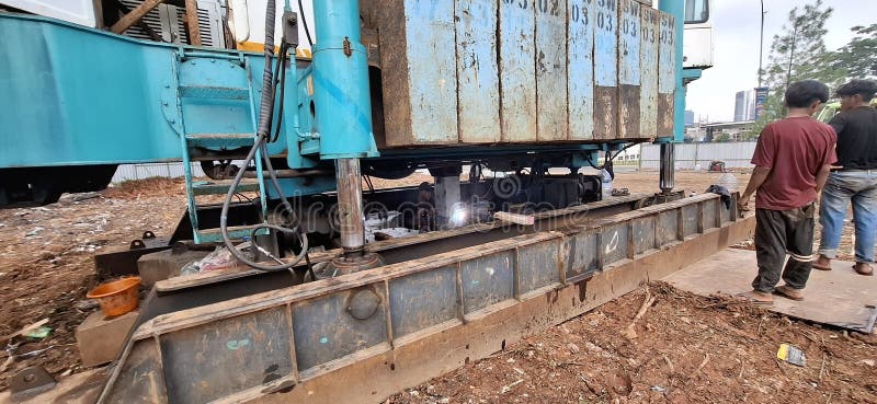 Two Workers are Observing the Pile Splicing Process Under the Hydraulic ...