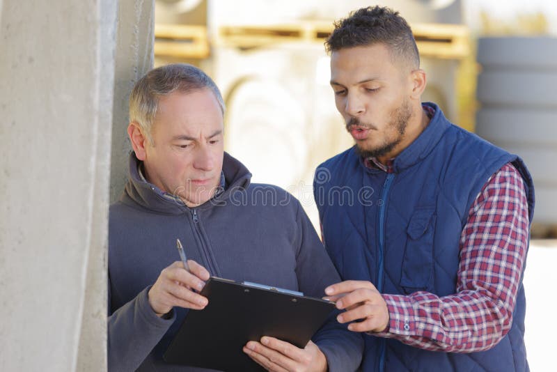 Two Workers Outside Factory Stock Photo - Image of checklist, manager ... Two Workers Outside Factory Stock Photo - Image of checklist, manager ...