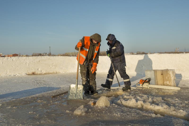 Two Workers in Overalls Remove Ice from the Hole Stock Photo - Image of ...