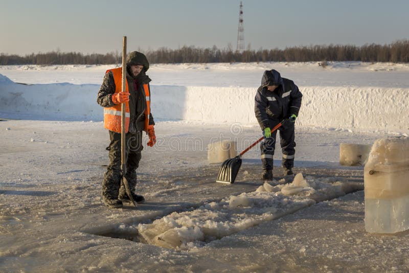 Two Workers in Overalls Remove Ice from the Hole Stock Photo - Image of ...