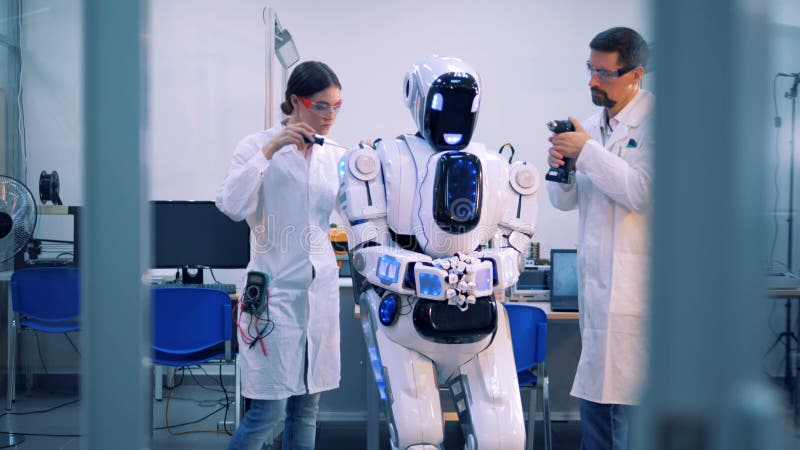 Two Engineers are Repairing a Human-like Robot Stock Video - Video of ...