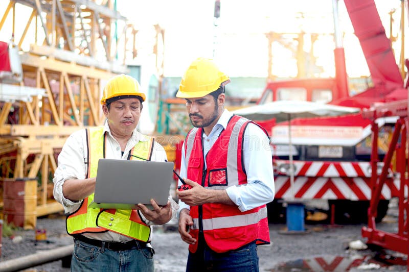 Two Workers with Safety Vest and Helmet Hold Laptop Computer for ...