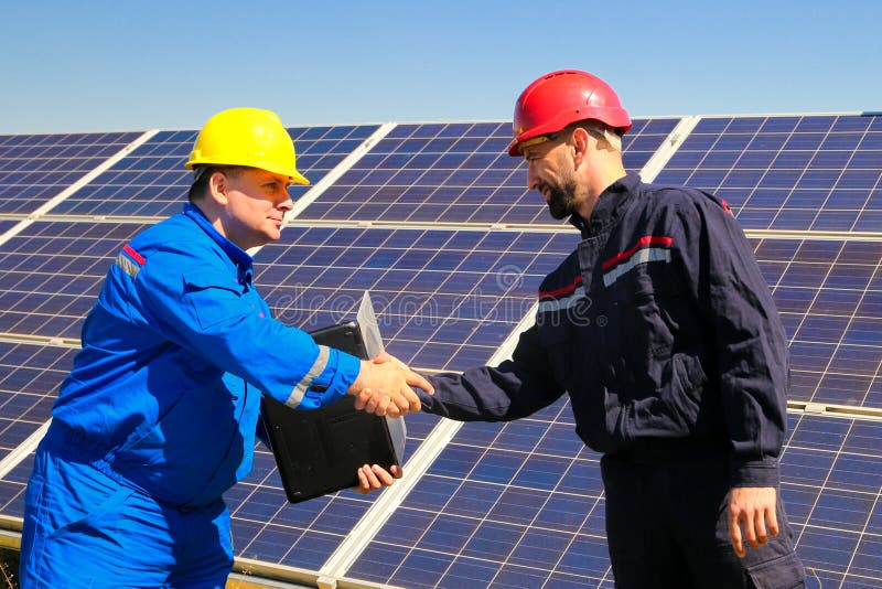 Two Workers Shake Hands in Front of the Solar Power Plant Stock Image ...
