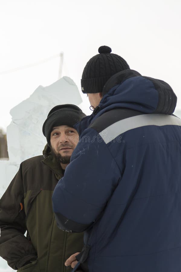 Two Workers at the Site of the Ice Camp Stock Photo - Image of city ...