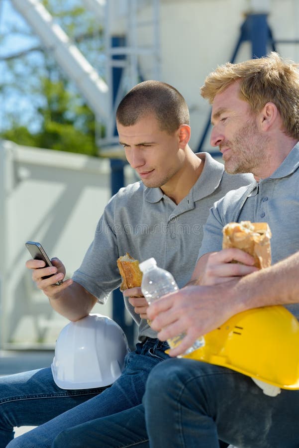 Two Workers Taking Break while Having Their Lunch Stock Photo - Image ...