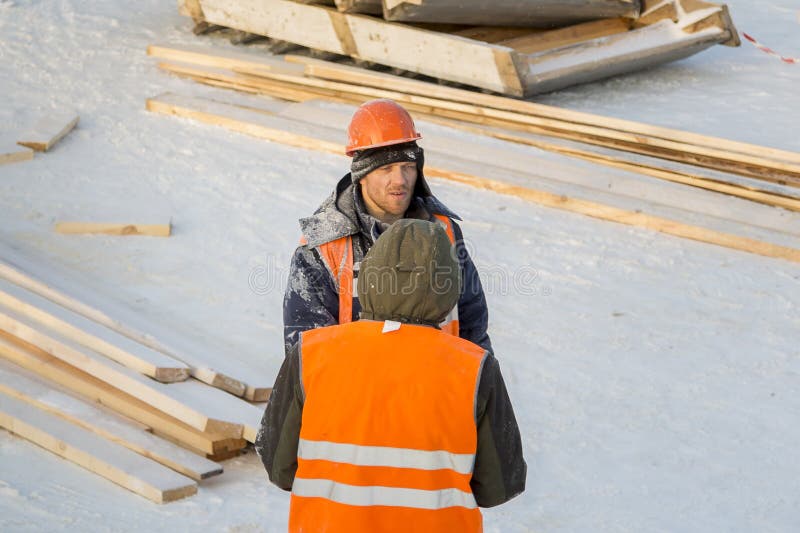 Two Workers Talk on the Assembly Site Stock Photo - Image of color ...