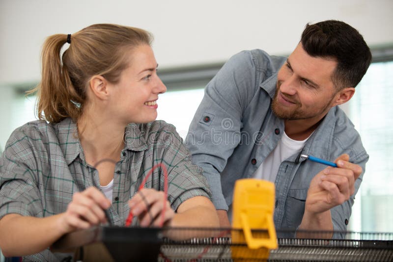 Two Workers Testing Appliance Using Multimeter Stock Image - Image of ...