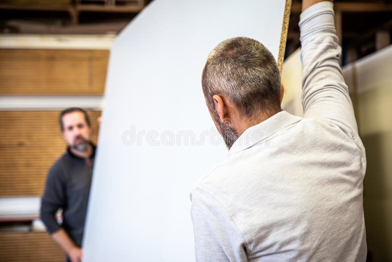 Two Workers Transport Different Wooden Boards on a Transport Aid Stock ...
