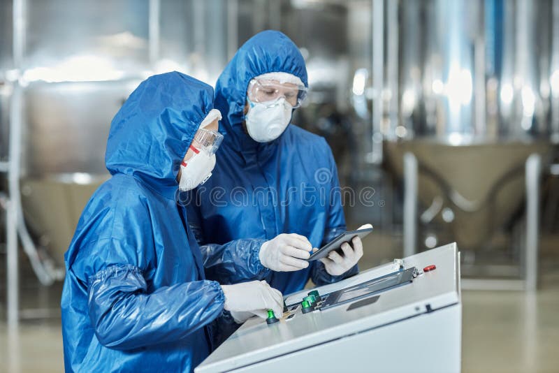 Two Workers Using Control Panel Operating Equipment at Factory Stock ...