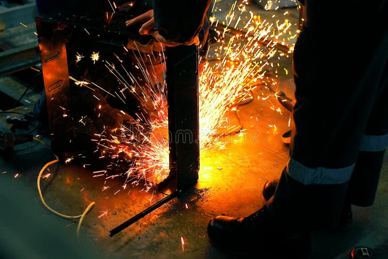 Two Workers Weld Metal Part in a Workshop at the Workplace. Bright ...