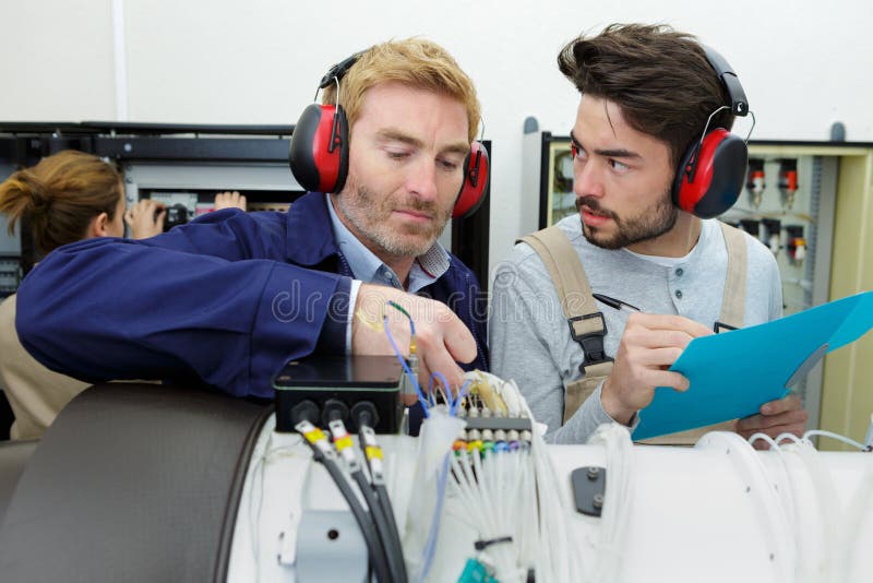Two Workers Working on Machine Stock Image - Image of machinery ...