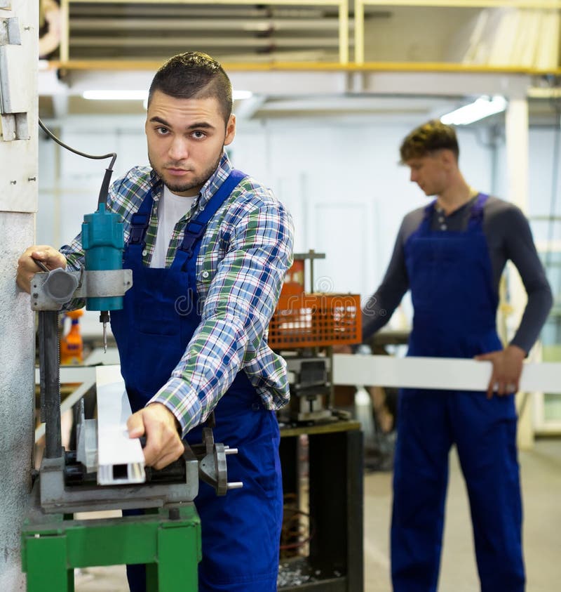 Two Workers Working on a Machine Stock Image - Image of production ...