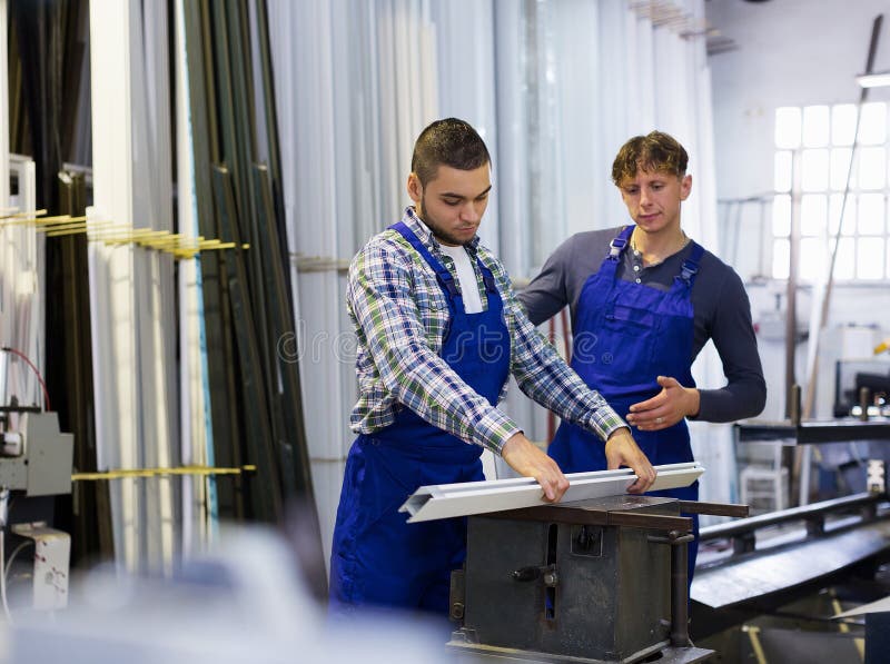 Two Workers Working on a Machine Stock Image - Image of depository ...