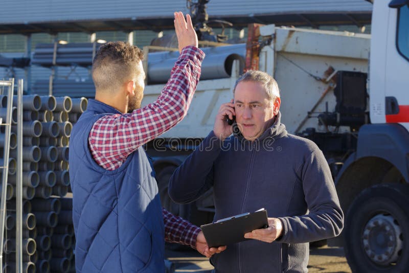 Two Workers Working Outside on Construction Site Stock Image - Image of ...