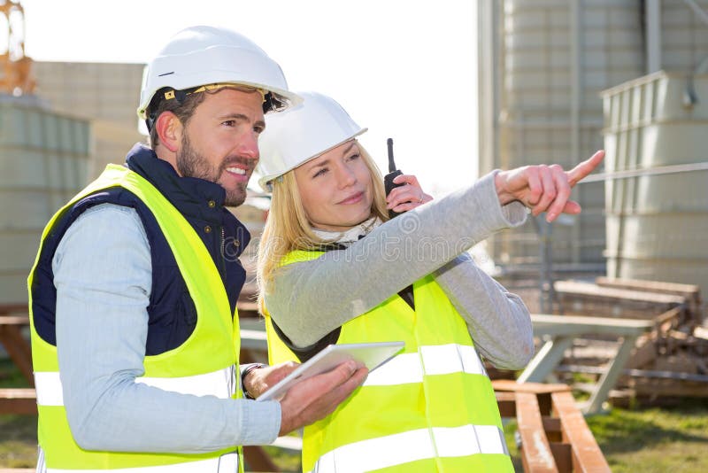 Two Workers Working Outside on a Construction Site Stock Photo - Image ...