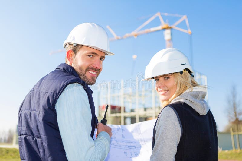Two Workers Working Outside on a Construction Site Stock Image - Image ...
