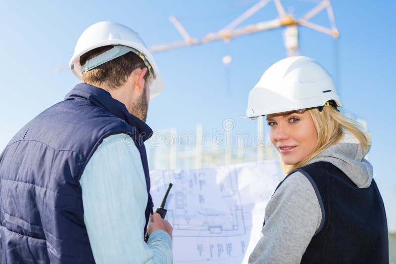 Two Workers Working Outside on a Construction Site Stock Image - Image ...