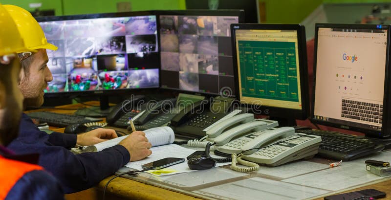 The Two Workers in Yellow Helmets in Control Panel in the Laboratory ...