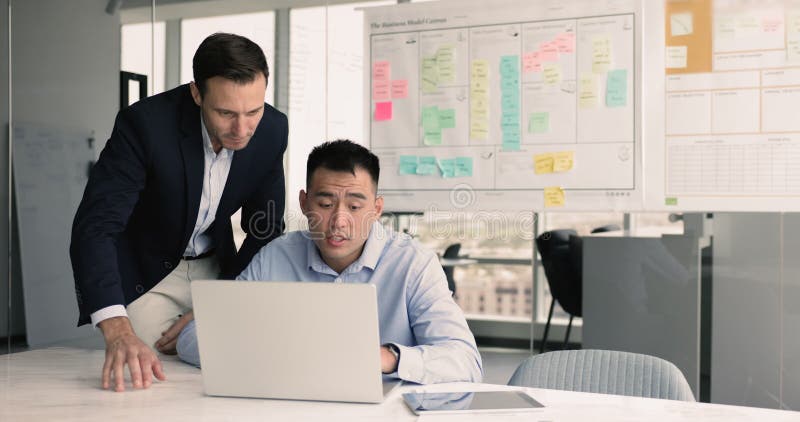 Two Workmates in Office Using Laptop for Discussion and Work Stock ...