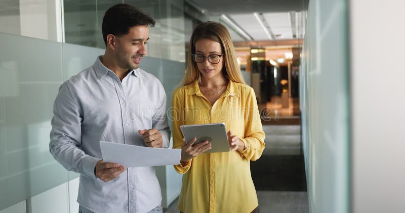 Two Workmates Speaking while Going Along Hallway in Office Stock ...