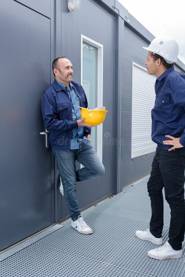 Two Workmen Chatting while on Break Stock Photo - Image of standing ...