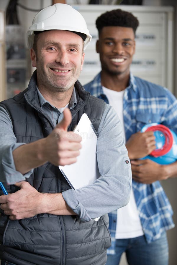 Two Workmen Making Thumbs-up Gesture Stock Image - Image of electrical ...