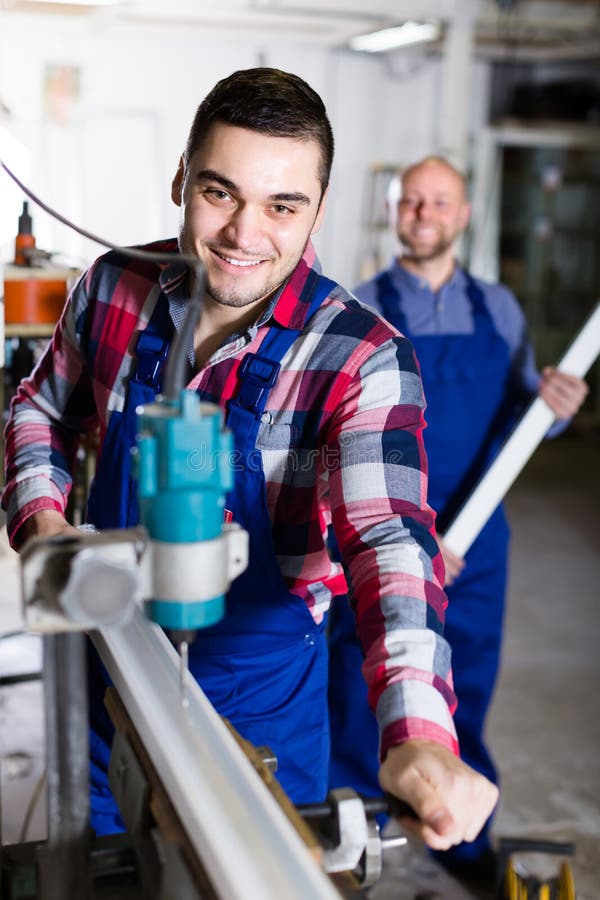 Two workmen in PVC shop stock image. Image of hand, caucasian - 51507231
