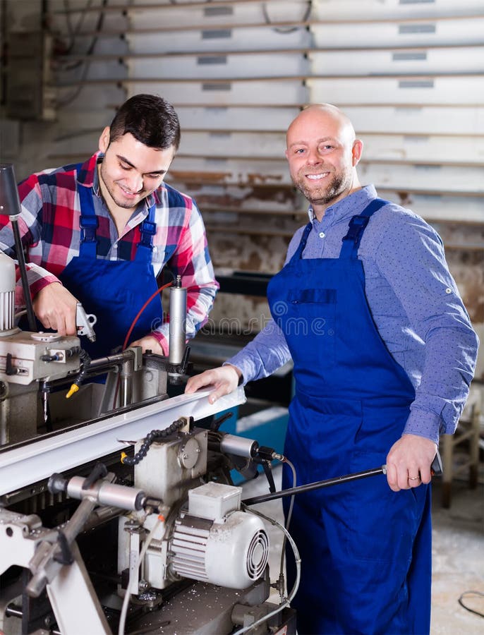 Two workmen in PVC shop stock image. Image of facility - 60762985