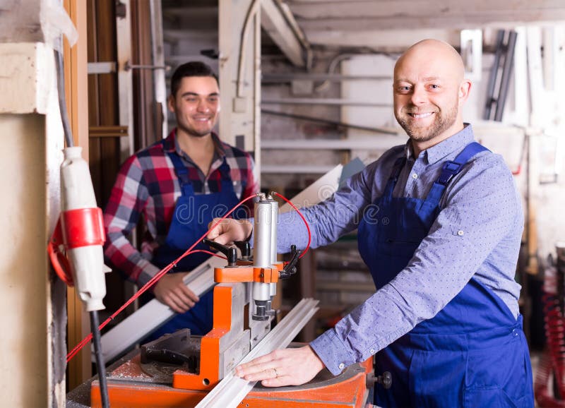 Two workmen in PVC shop stock image. Image of facility - 60762985