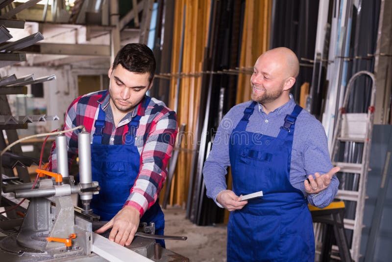 Two Workmen Working on Machine Stock Photo - Image of producing, indoor ...