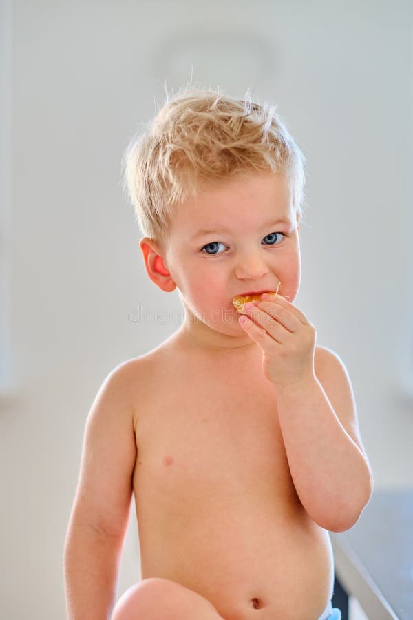 Two Year Old Boy Eating Orange Stock Photo - Image of orange, sweet ...