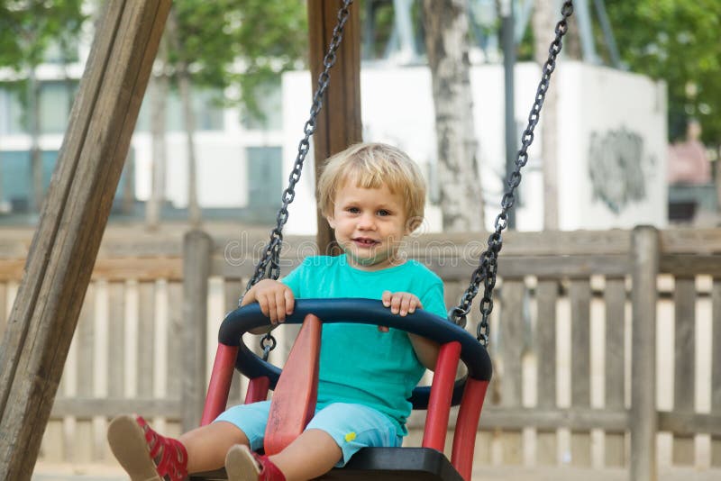 Child on swing stock photo. Image of game, house, outside - 34892344