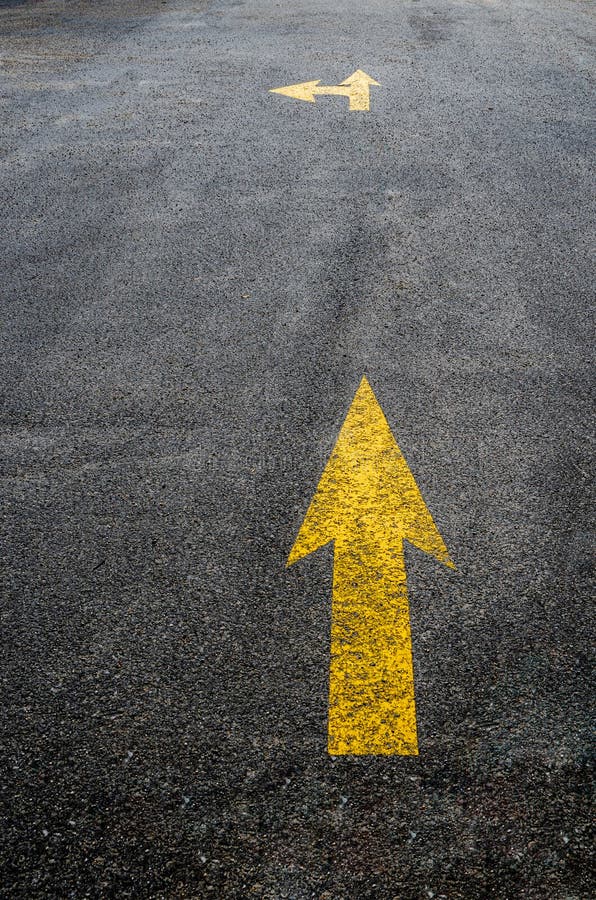 Two Yellow Arrows on Pavement Stock Image - Image of pointing, yellow ...