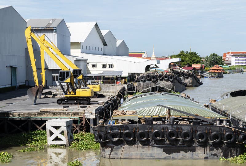 Two Yellow Backhoe on Dock and Barges Stock Image - Image of industrial ...