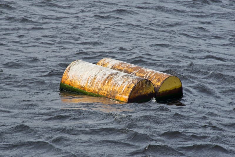 Two Yellow Barrels Drift on Water Stock Image - Image of industry, dust ...