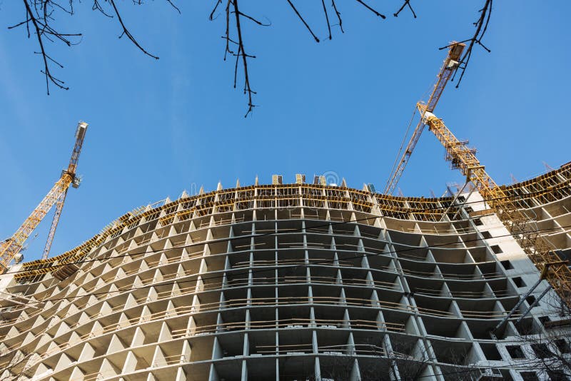 Two Yellow Construction Cranes Running Near the House Under ...