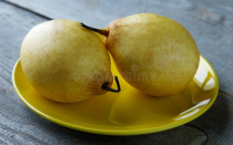 Two Yellow Pears on the Plate on a Table Stock Image - Image of ...