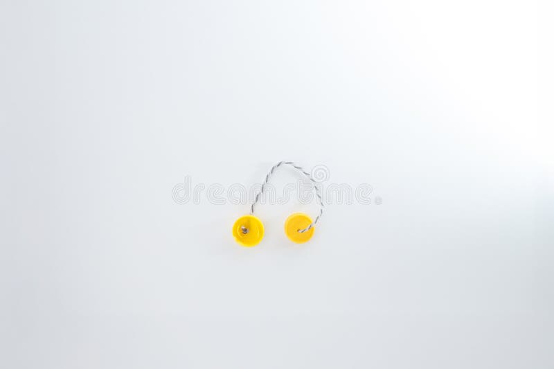 Two Yellow Plastic Bottle Caps Connected by String. Creative Use of ...