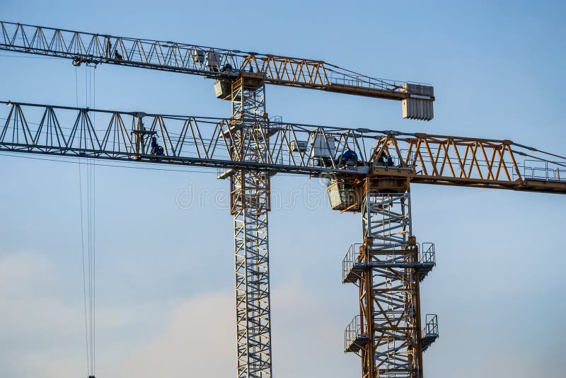 Two Yellow Tower Cranes. Hoisting Crane Stock Photo - Image of rigging ...