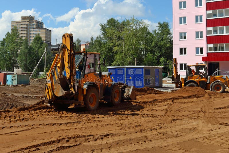 Two Yellow Tractors Work on Construction Site at Summer Sunny Da Stock ...