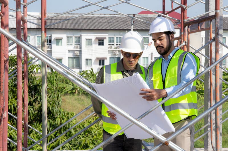 Two Young Architect Discussion or Contractor Man while Looking ...