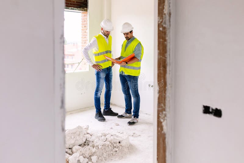 Two Young Architects Male Working Together at Construction Site Stock ...