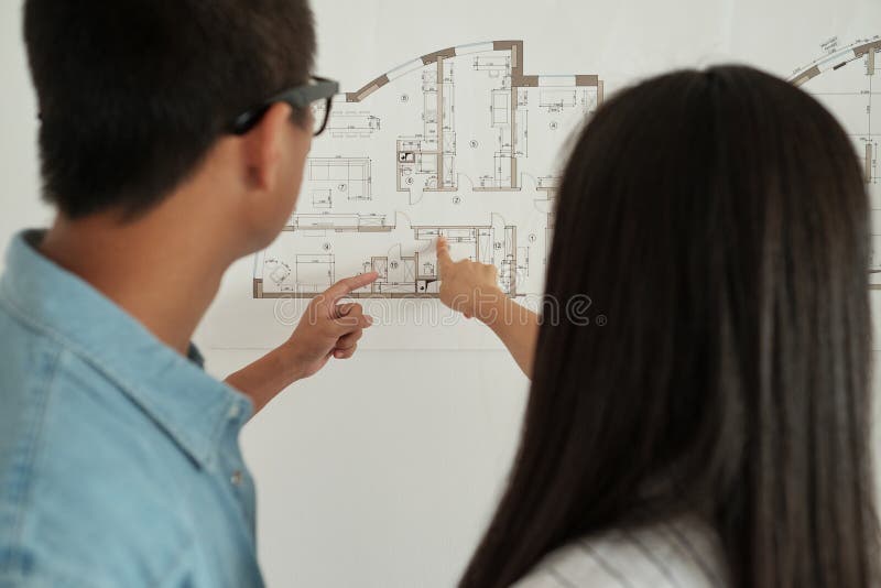 Two Young Architects Pointing at Large Sketch Stock Photo - Image of ...