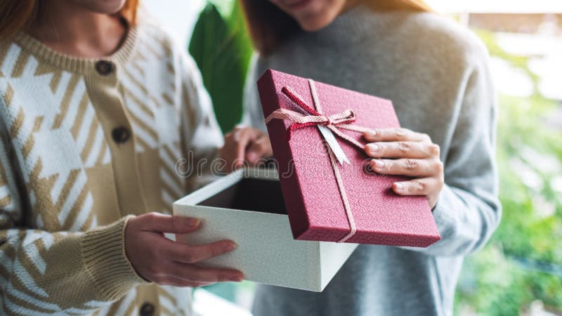 Two Women Opening a Gift Box Together Stock Image - Image of face ...