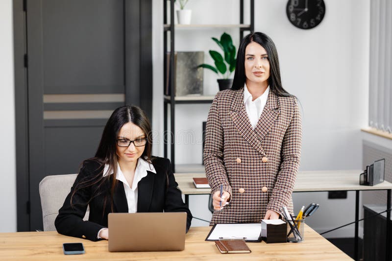 Two Young Attractive Women are Working in the Office. Women Working on ...