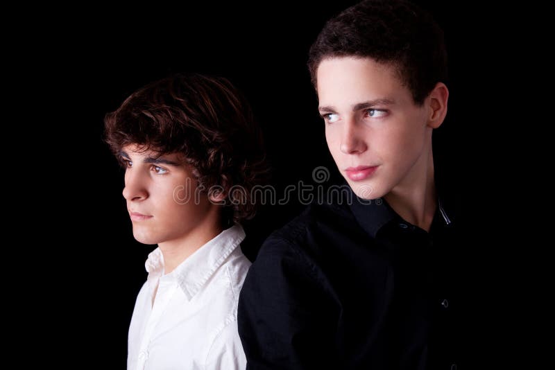 Two Young Back To Back, Isolated on Black Stock Image - Image of ...