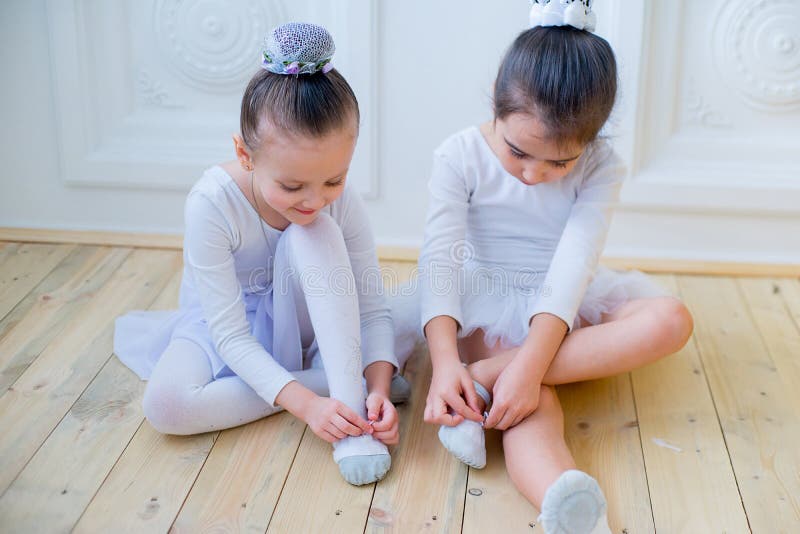 Two Young Ballet Dancers Preparing for Lesson Stock Image - Image of ...
